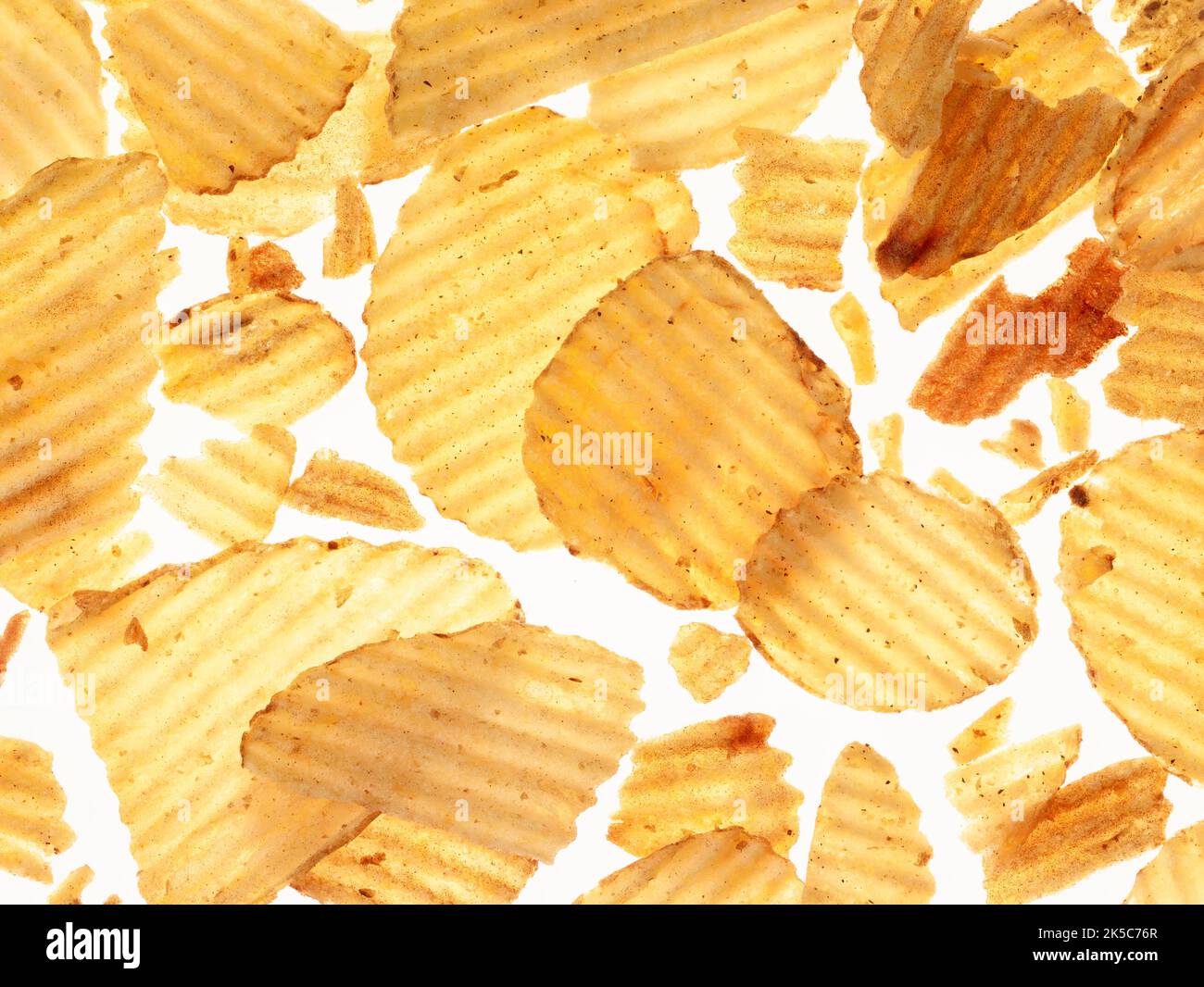 Clean background crinkle cut potato crisps in close up, food snack ...