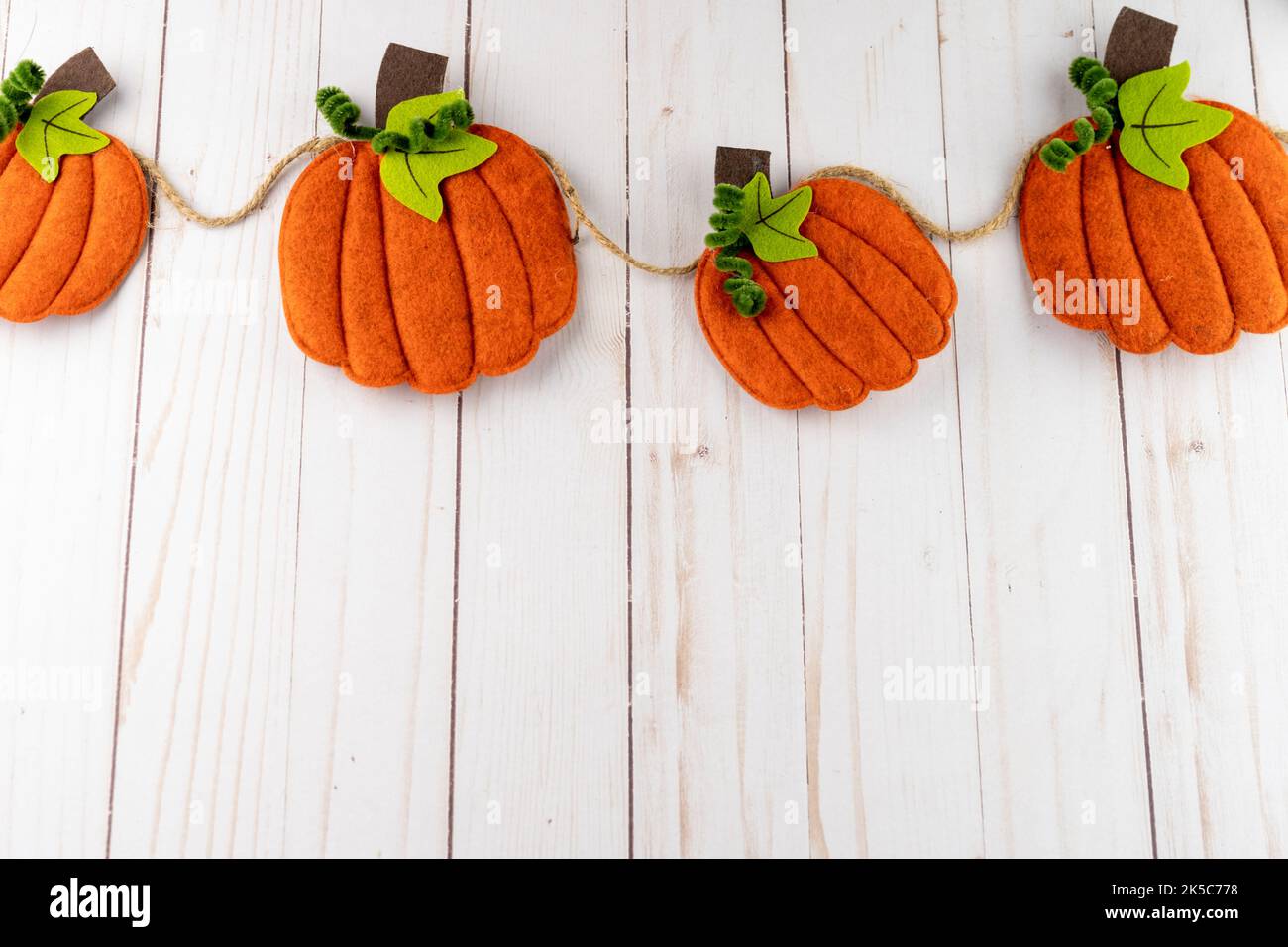 Felt pumpkin border on a wood background, with copyspace, for Halloween ...
