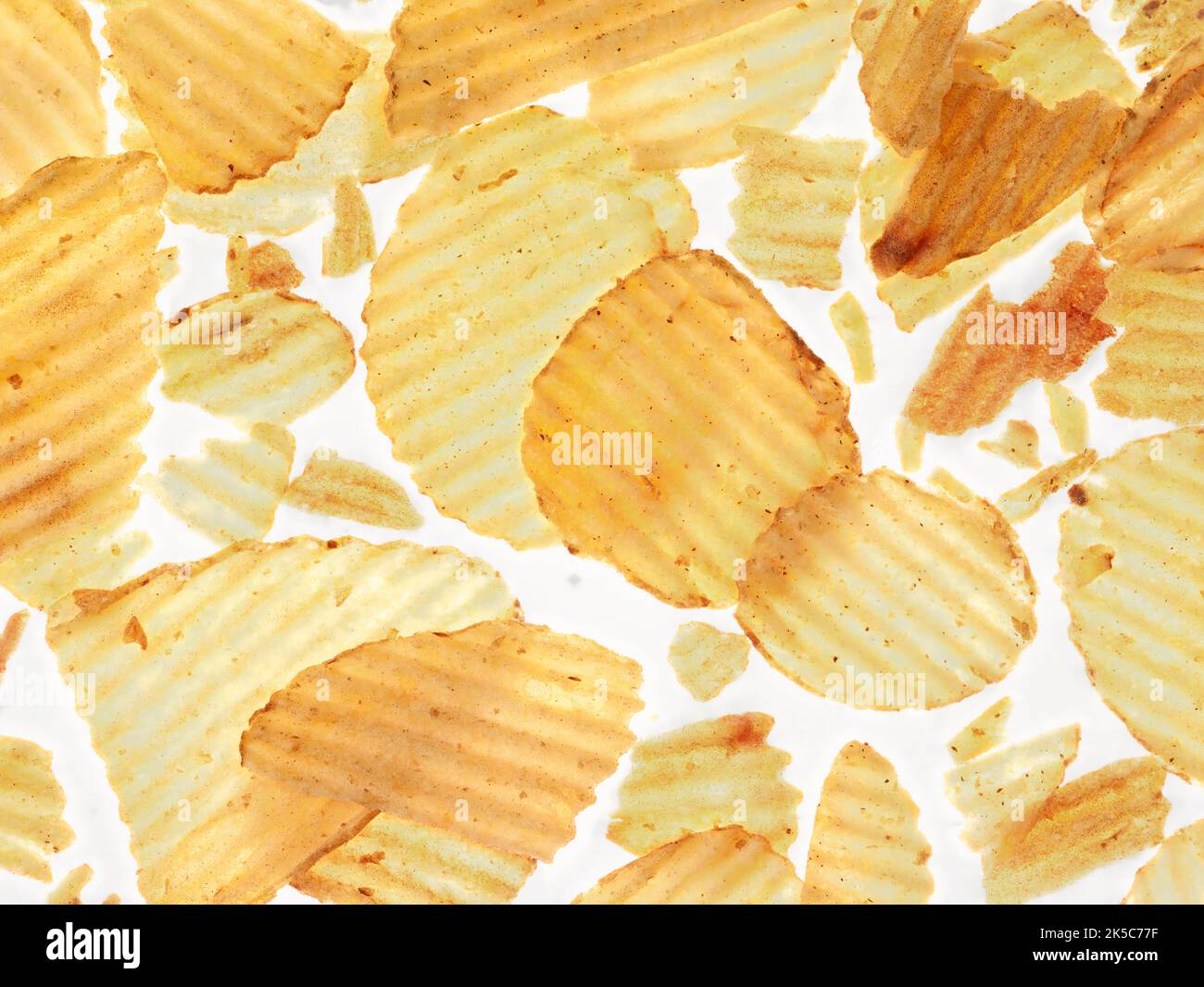 Clean background crinkle cut potato crisps in close up, food snack ...