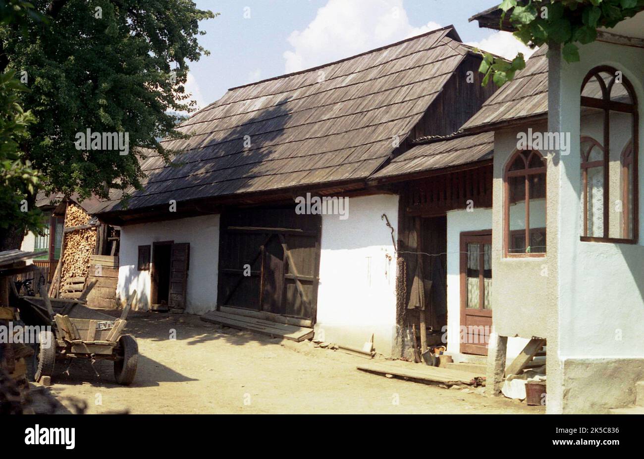 Bistrița-Năsăud County, Romania, 2000. Large barn in a courtyard, with ...