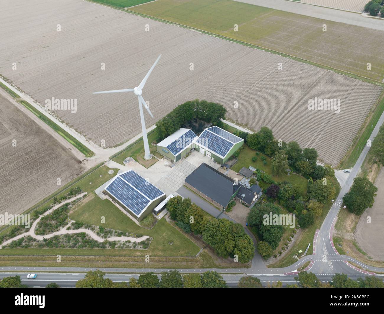 Modern agriculture farm with solar panels and wind turbine for ...