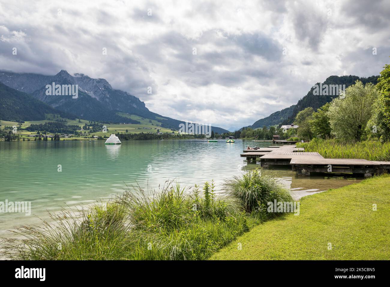 View over the Walchsee, lake shore with bathing jetty, on the left the ...