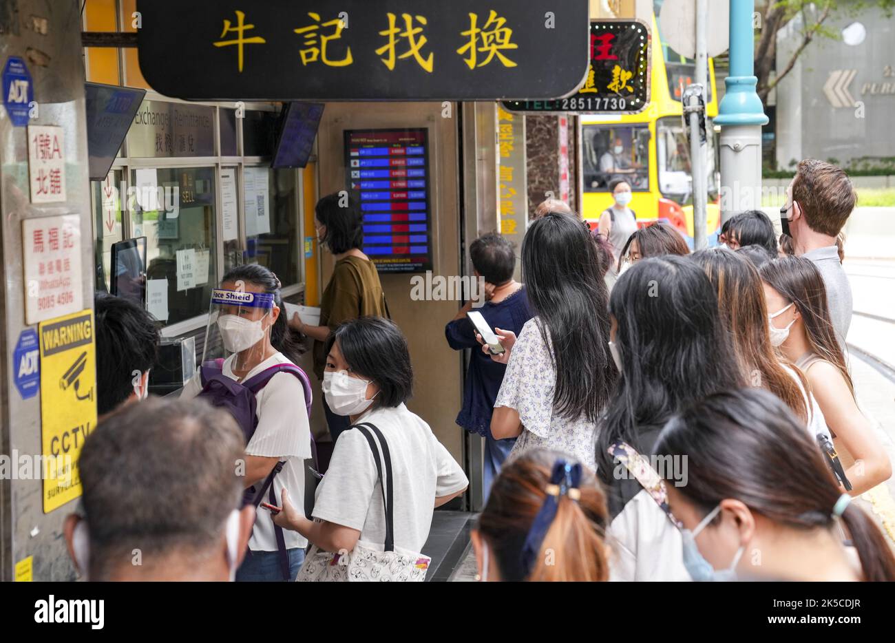 People queue up for change money outside a currency exchange shop at ...