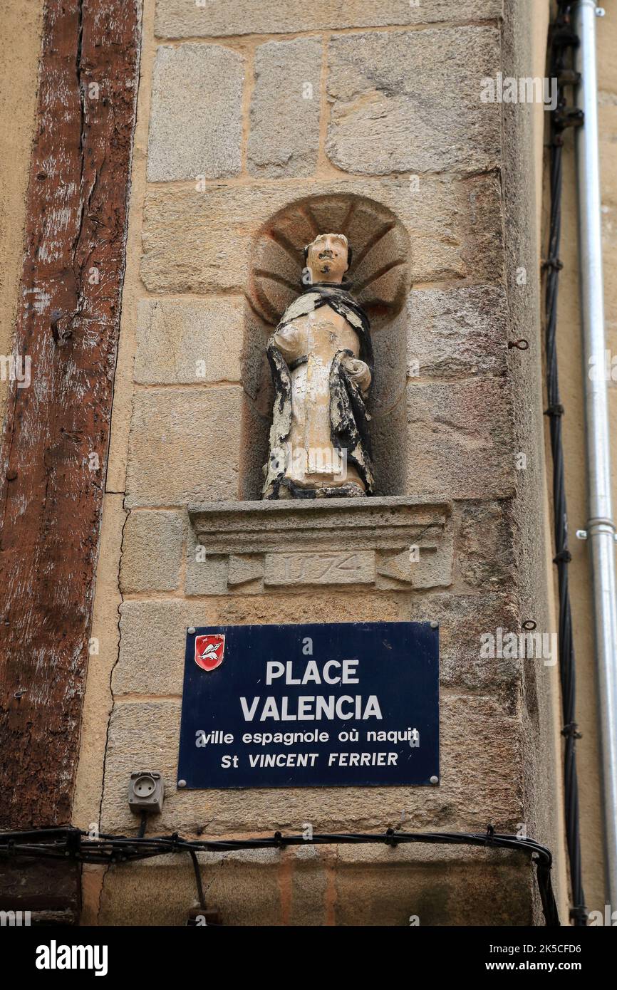 Statue of Saint Vincent Ferrier on side of building above street sign ...