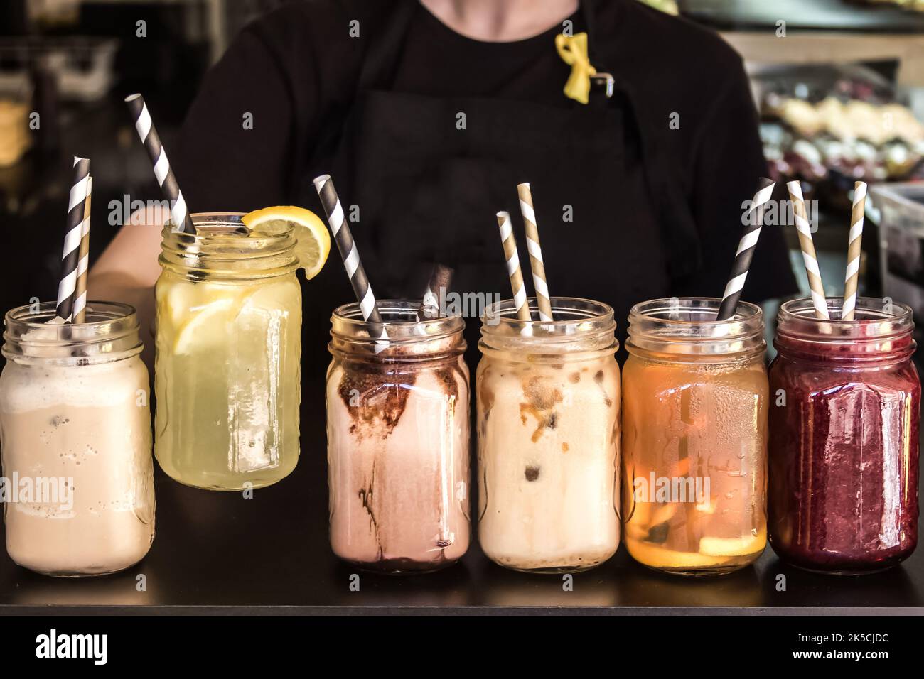 A woman holds in her hands a refreshing tropical ice drinks on a hot summer day. Ice Drinks in ...