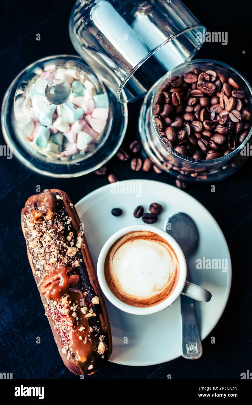 Top view of Traditional French dessert eclair with dark chocolate and ...