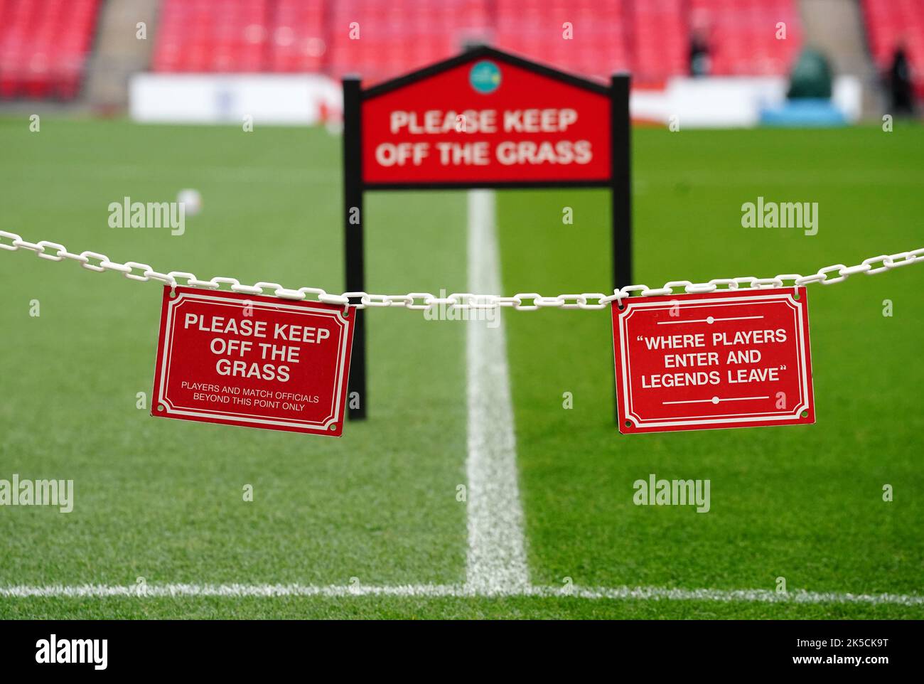 A "Please keep off the grass" sign and a "Where players enter and ...