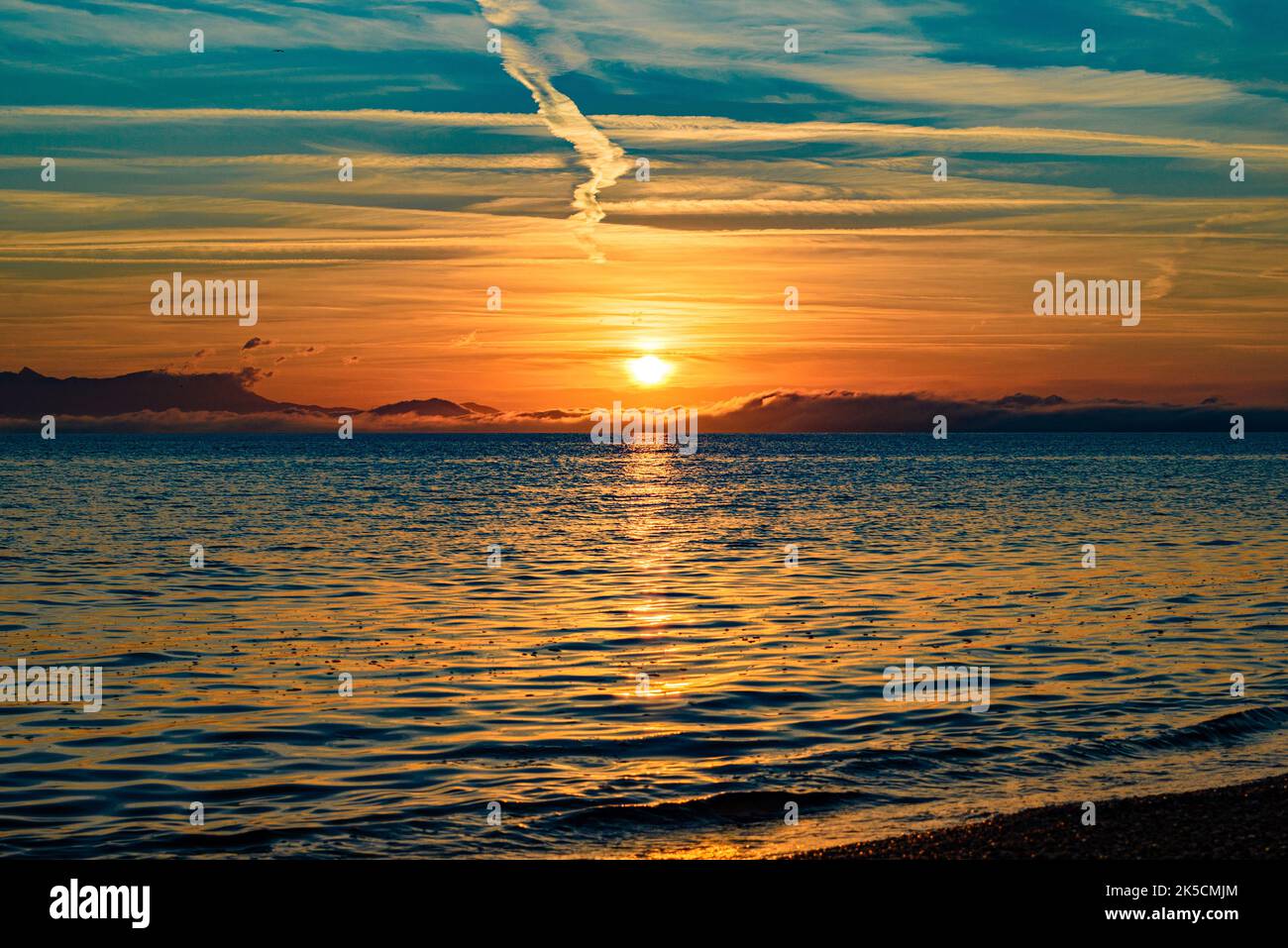 Seashore sunsets colors scenery Stock Photo - Alamy