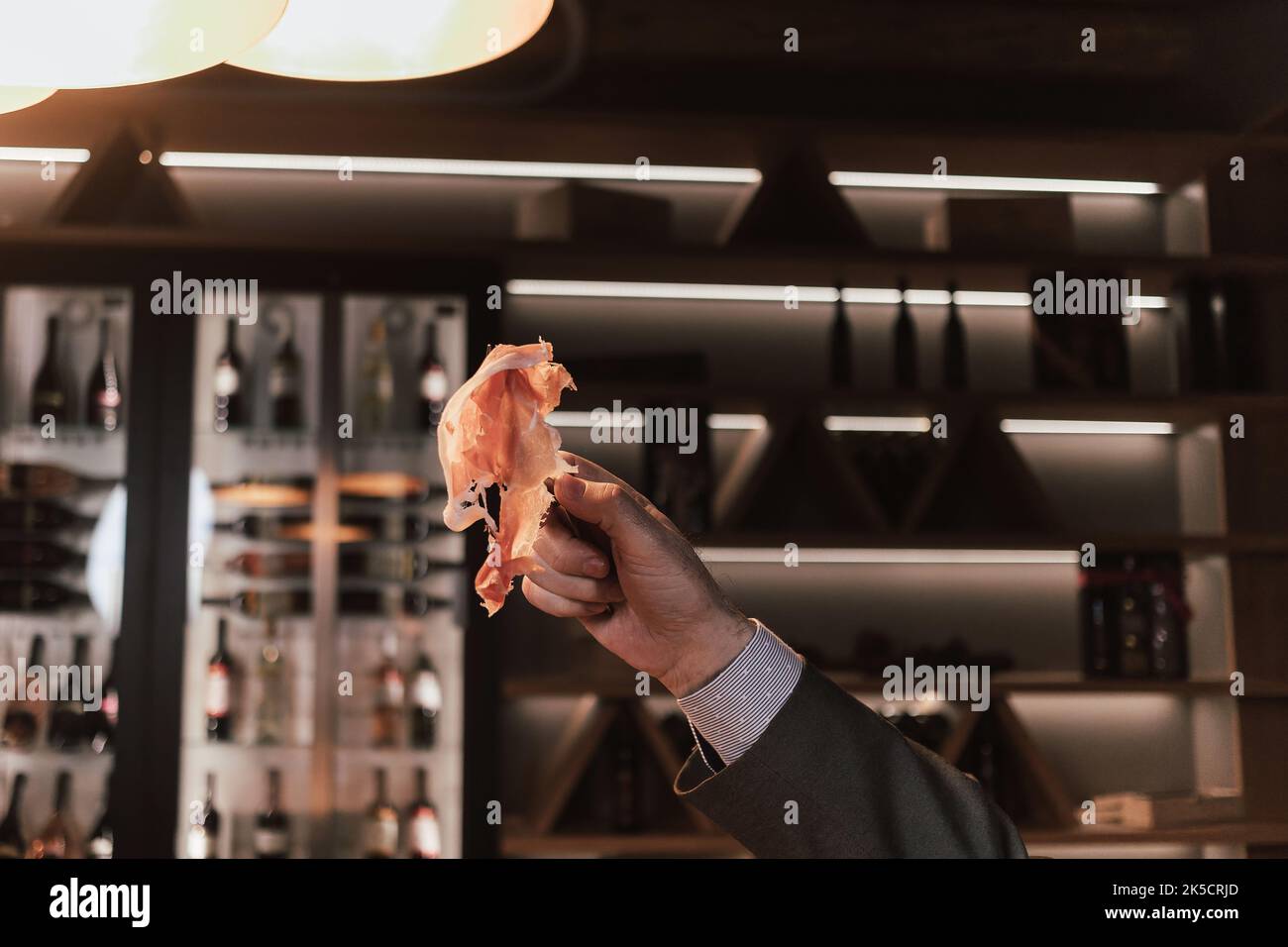 People drinking wine and eating cold cut meat in a wine cellar Stock ...