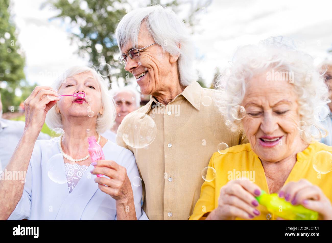 Group of happy elderly people bonding outdoors at the park - Old people ...