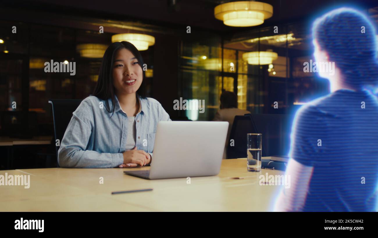 Young asian woman receives a call via an abstract futuristic screen ...