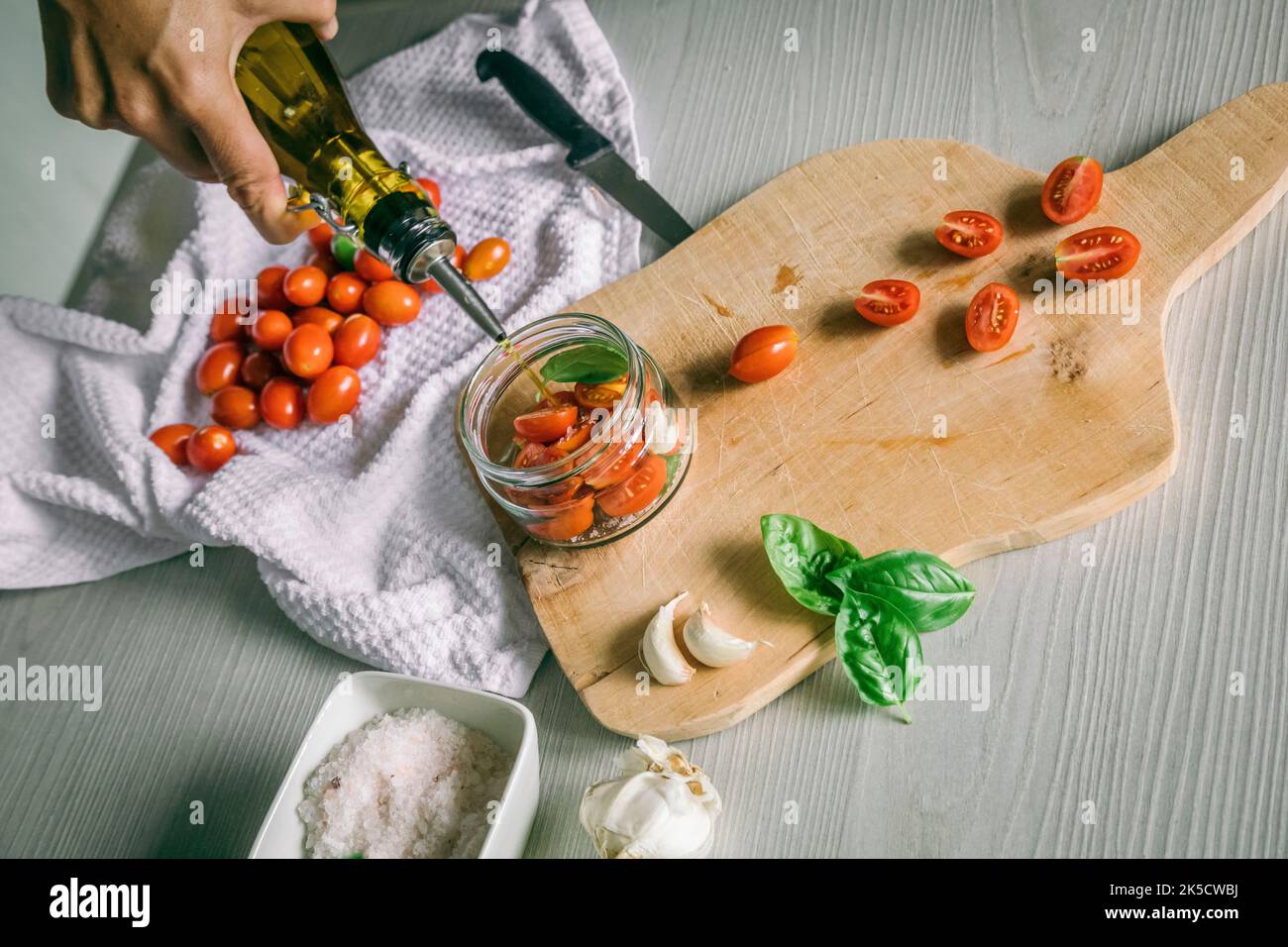 homemade preparation, tomatoes in oil with garlic, basil Stock Photo ...