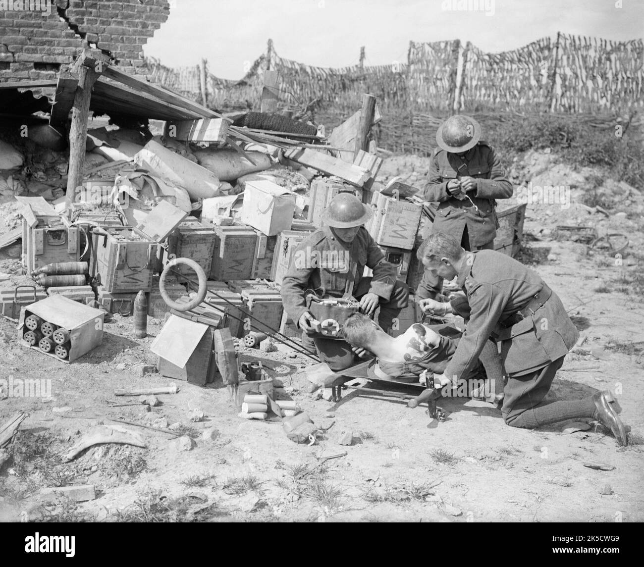 A doctor tending a wounded soldier at a Regimental Aid Post set up in a ...