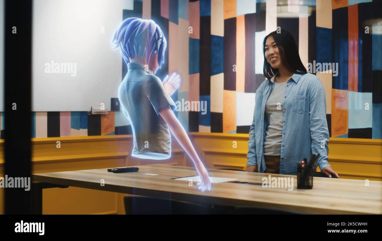 An avatar of a girl gives presentation to an asian woman through an abstract hologram screen in ...
