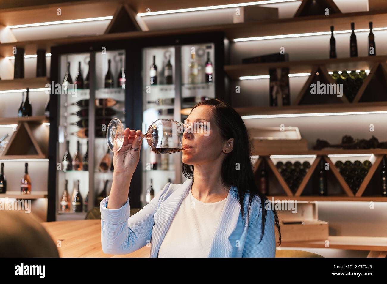 People drinking wine and eating cold cut meat in a wine cellar Stock ...