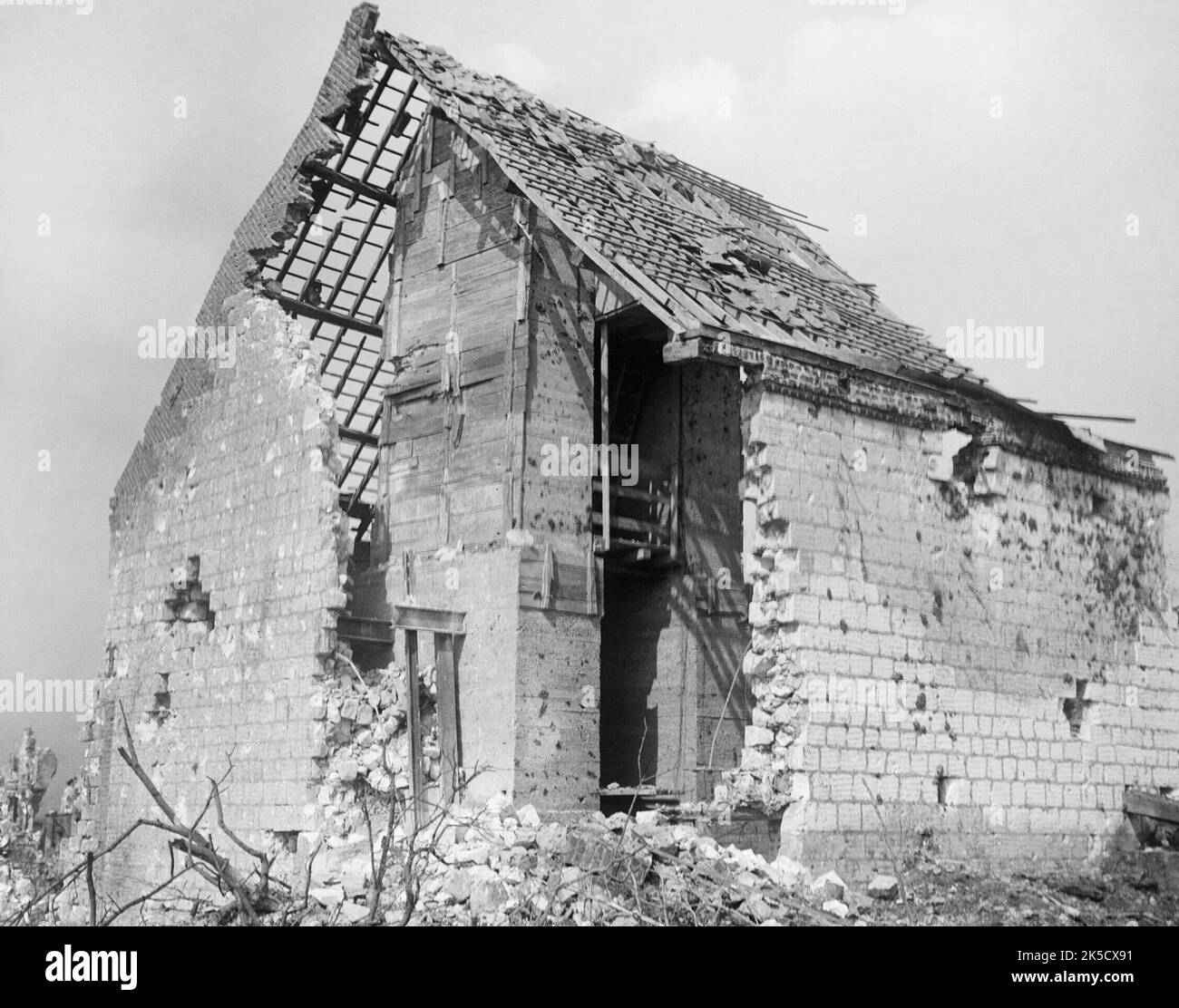 A German concrete observation post built into the ruins of a house in ...