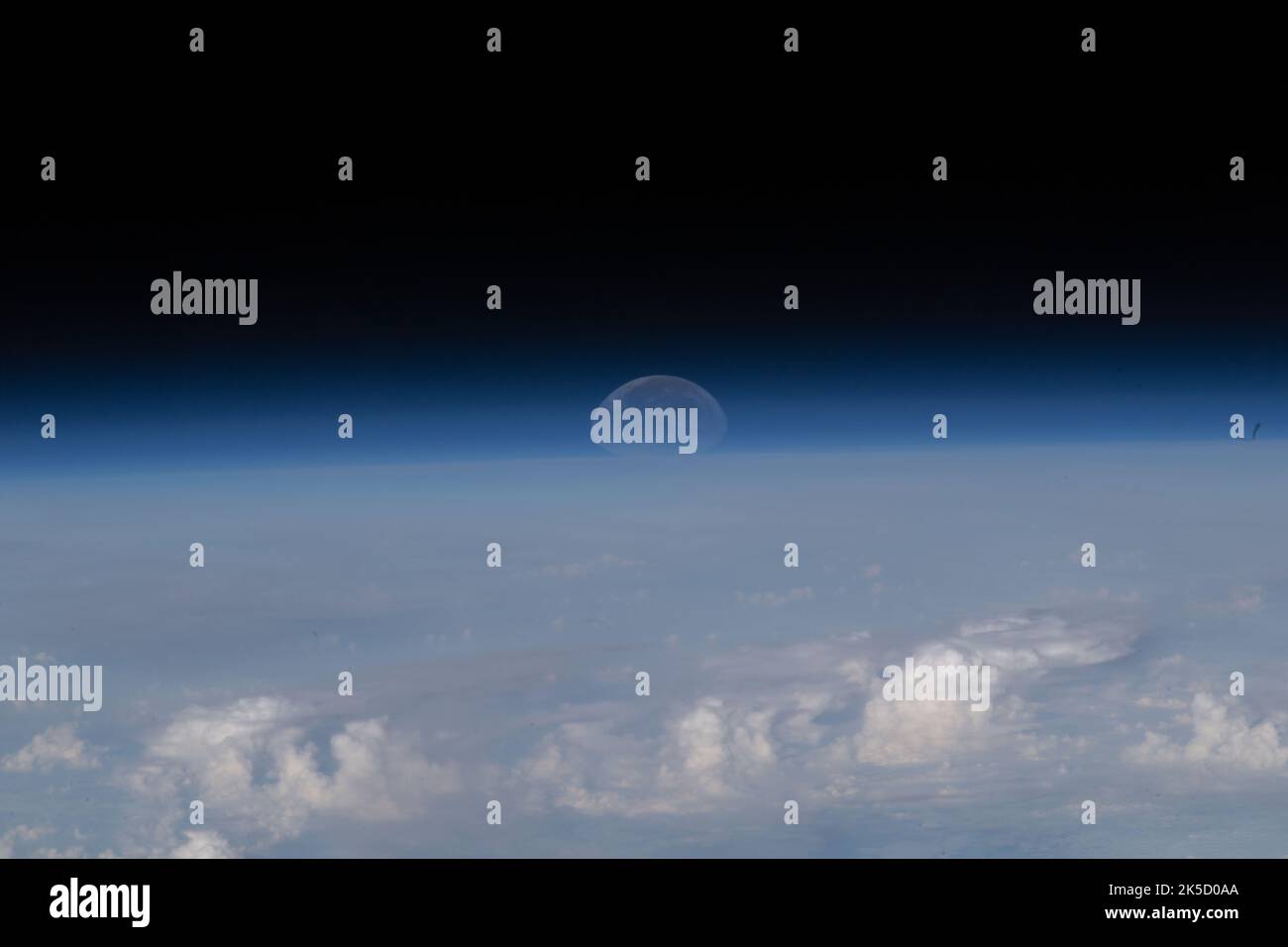 From 261 miles above the Himalayas near Kathmandu, Nepal, the Moon sets ...