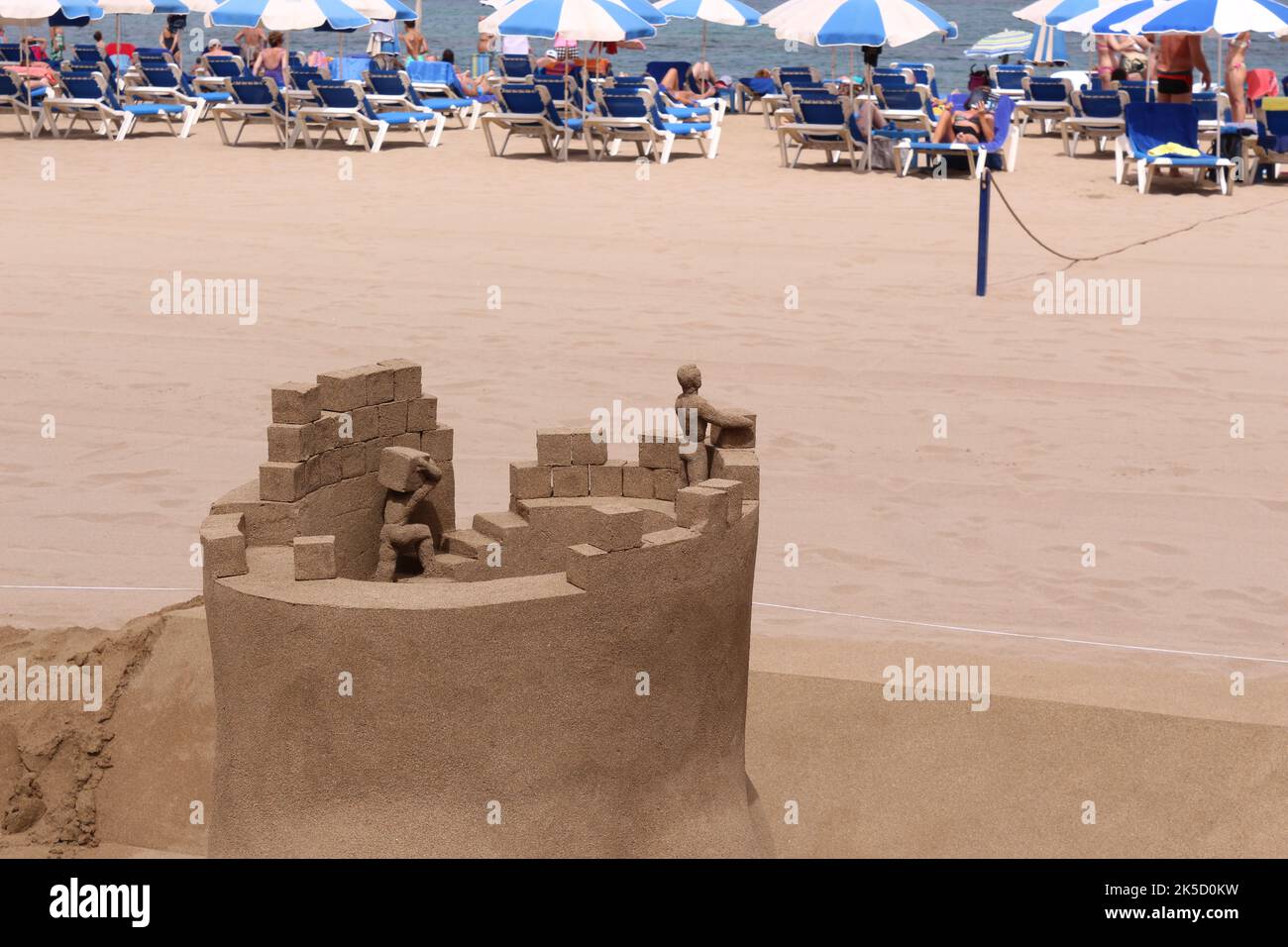 Sand men building a sand castle with background beach and sea in Las ...