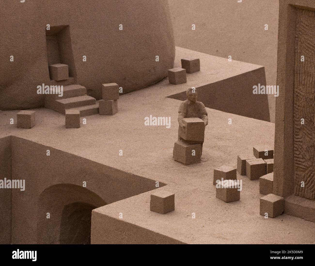 Sand man building a sand castle. Concept Idea or business growing Stock ...