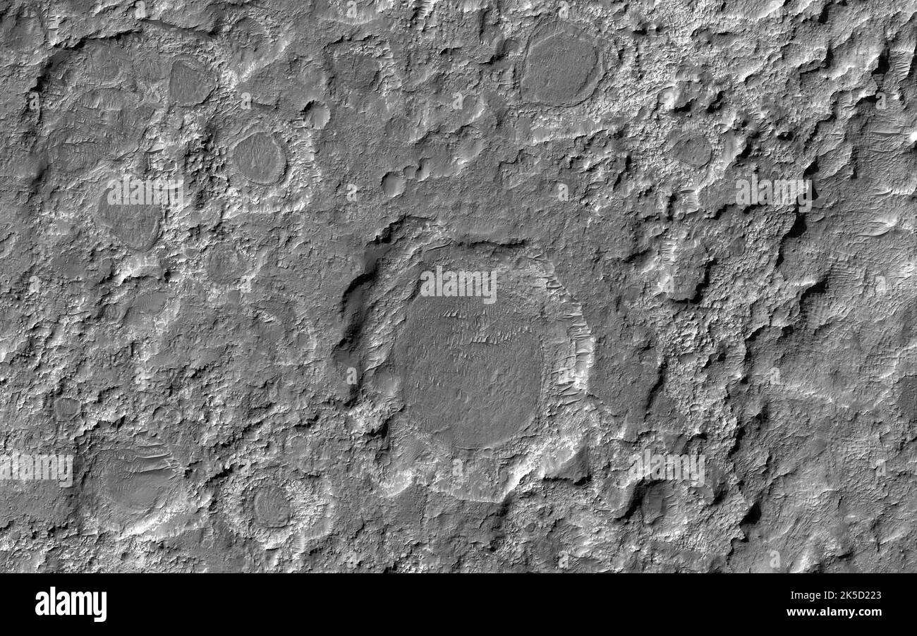 Mars Reconnaissance Orbiter images show eroded dark circular features ...