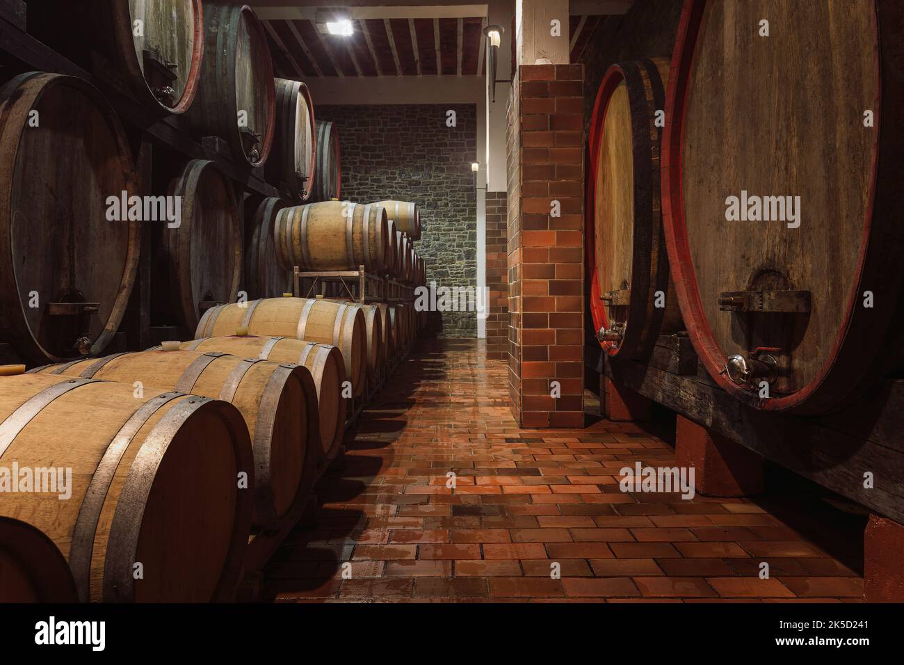 Underground dark cool arched wine cellar, storage room with large ...