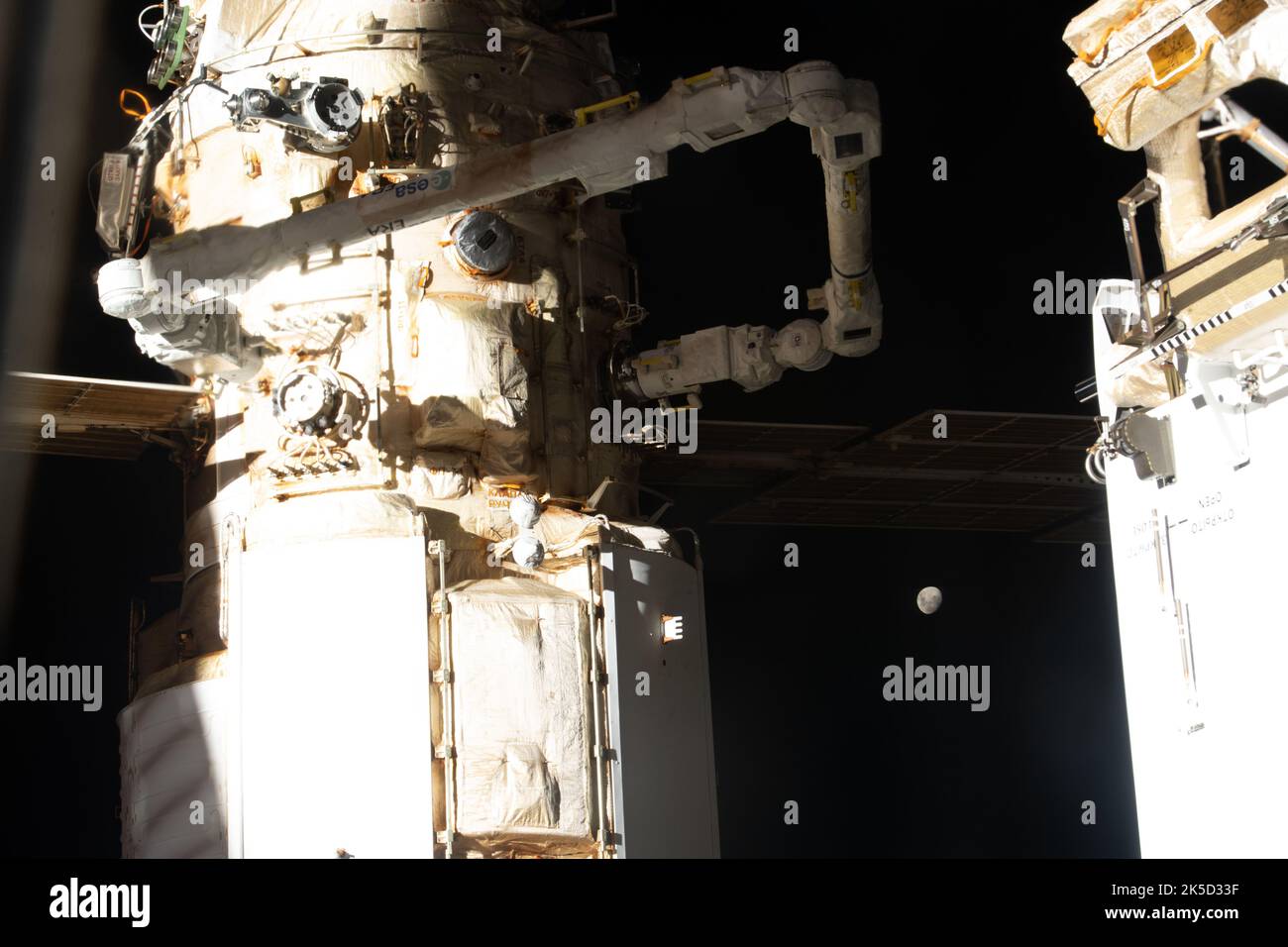 During a lunar eclipse, the Moon is visible between the ISS Nauka laboratory and Rassvet module ...