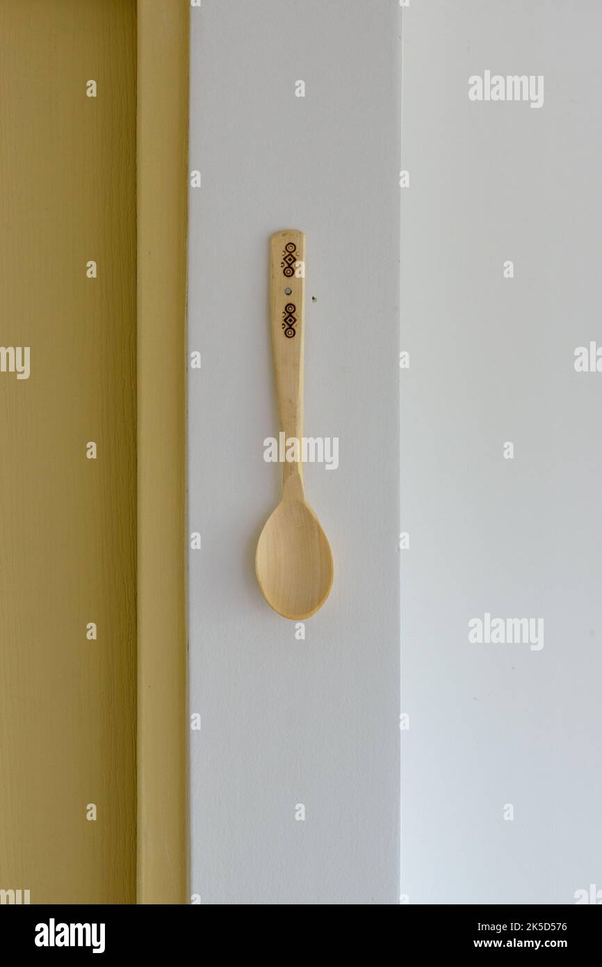 A wooden spoon hanging from a wall Stock Photo - Alamy