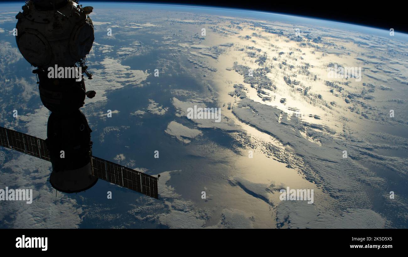 The silhouetted Soyuz MS-21 crew ship docked to the Prichal docking ...