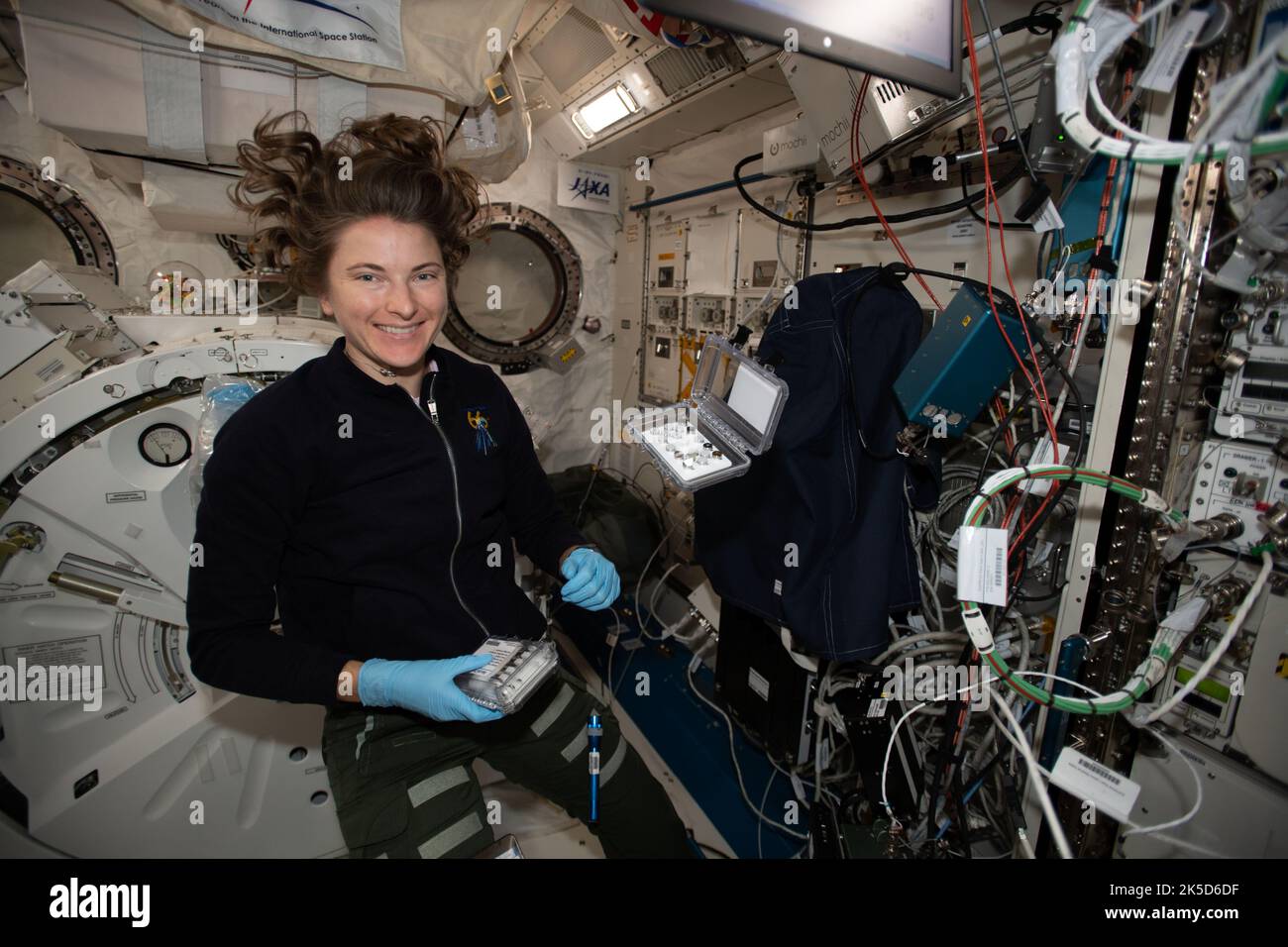 NASA astronaut Kayla Barron sets up the Mochii microscope. Mochii is a ...