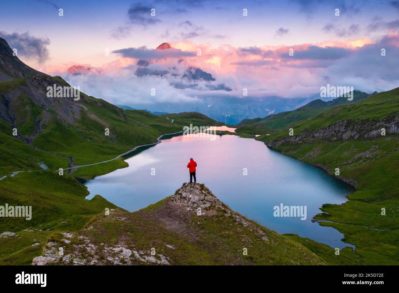Aerial view of a person admiring the Bachalpsee lake during a summer ...