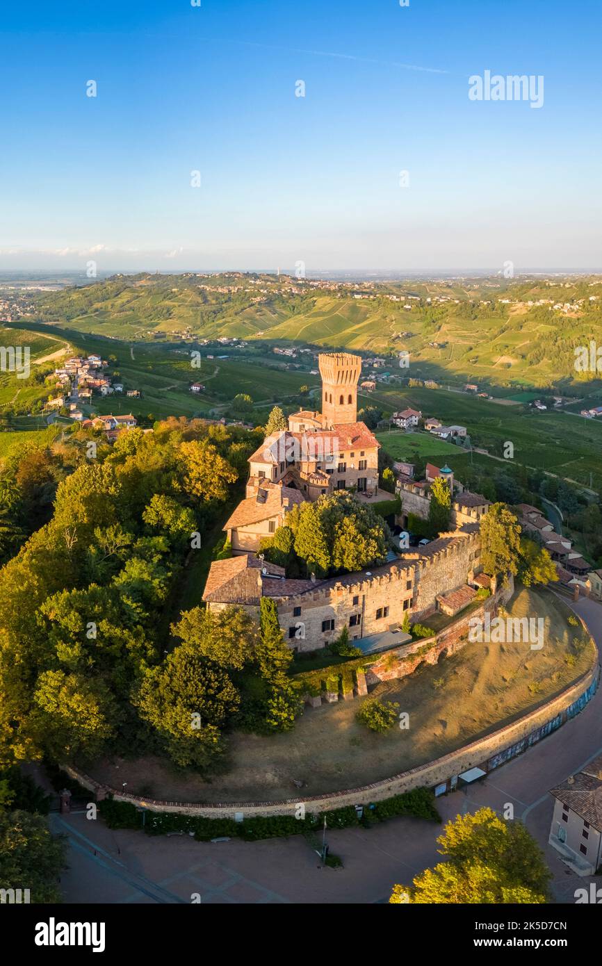 Aerial view of the Cigognola castle and vineyards at sunset. Cigognola ...