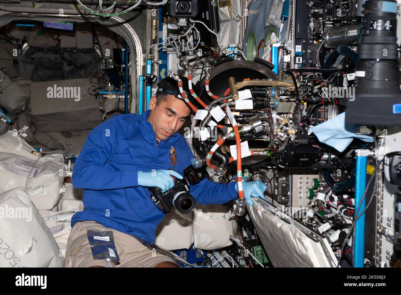 NASA astronaut and Expedition 66 Flight Engineer Raja Chari replaces hardware inside the ...