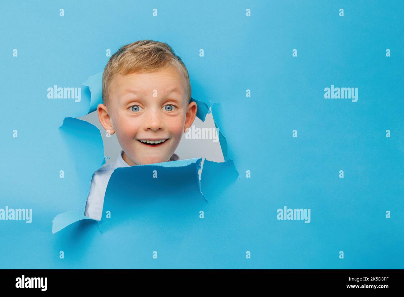 Happy Cute Boy Is Having Fun Played On Blue Background Wall Climbs 7597