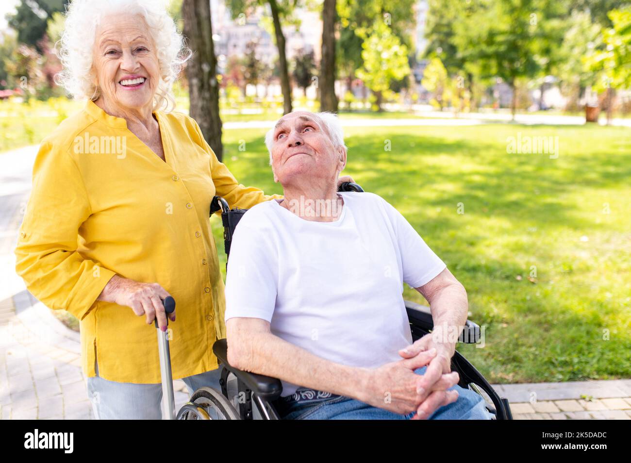 Beautiful senior couple with disability outdoors - Old people in the ...