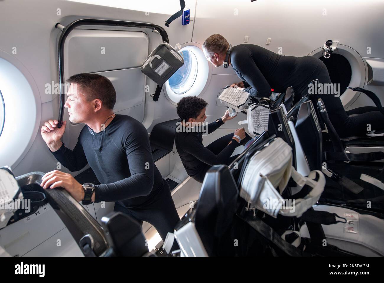 NASA astronauts Kjell Lindgren, Jessica Watkins, and Bob Hines look out ...