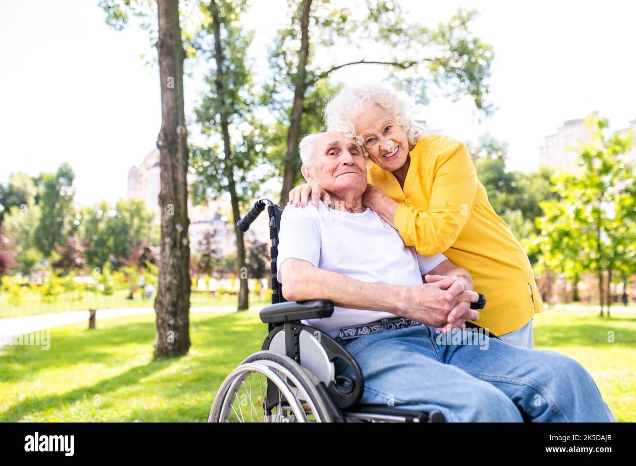 Beautiful senior couple with disability outdoors - Old people in the ...