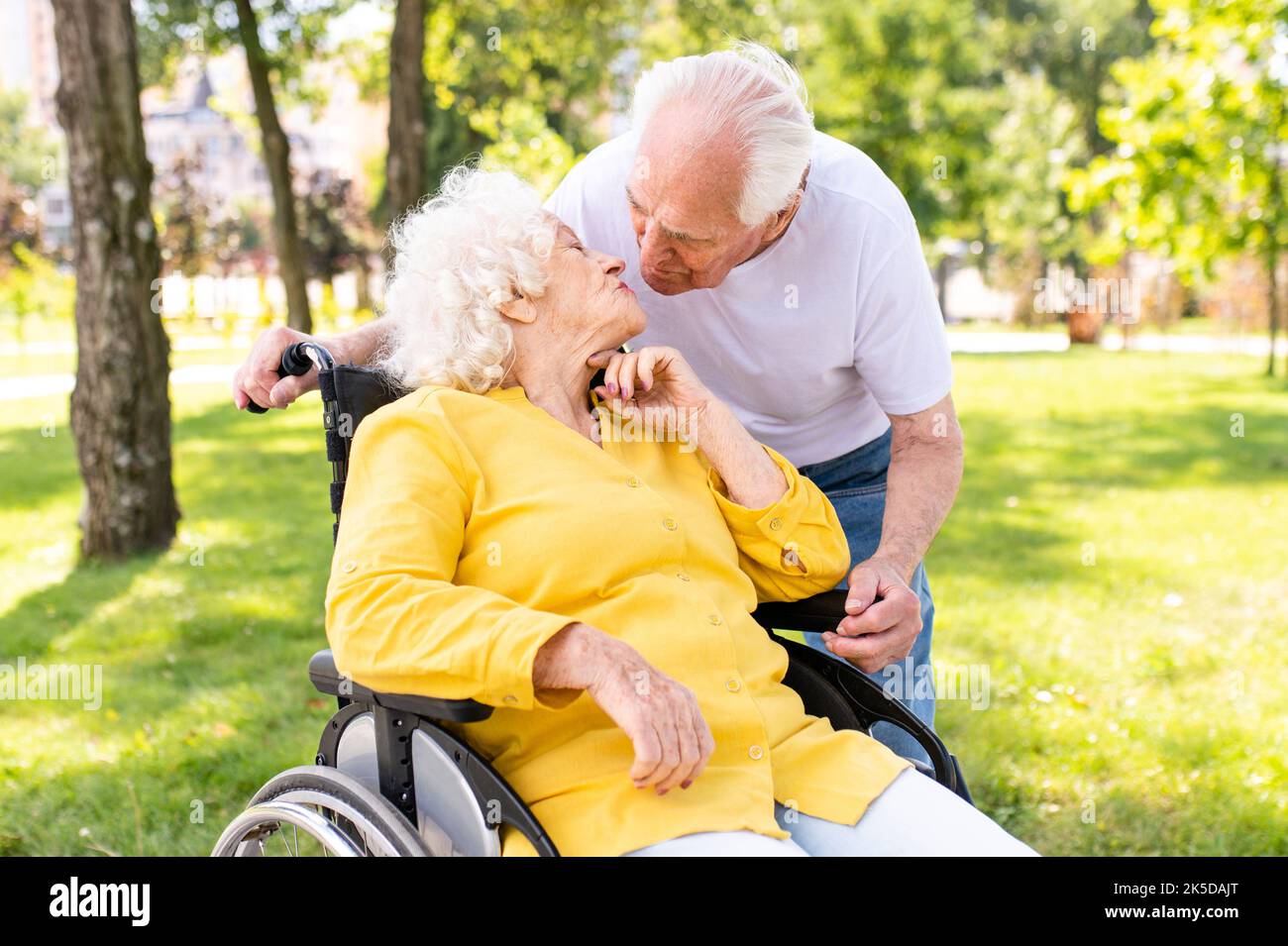 Beautiful senior couple with disability outdoors - Old people in the ...