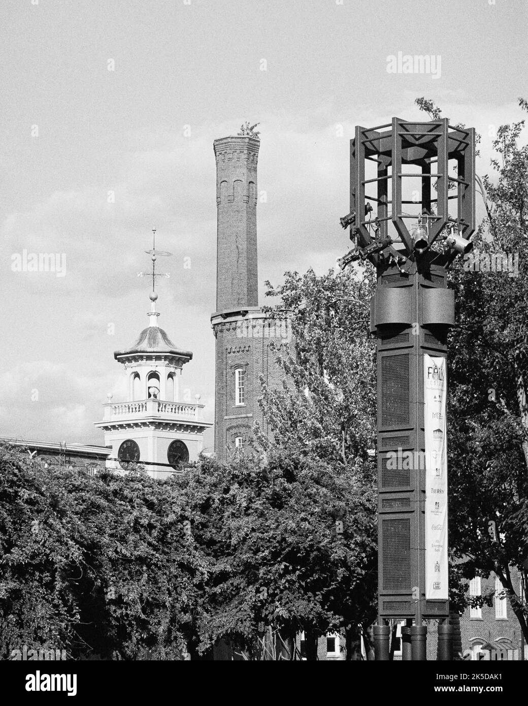 A smoke stack from a closed cotten mills rise above the trees in ...