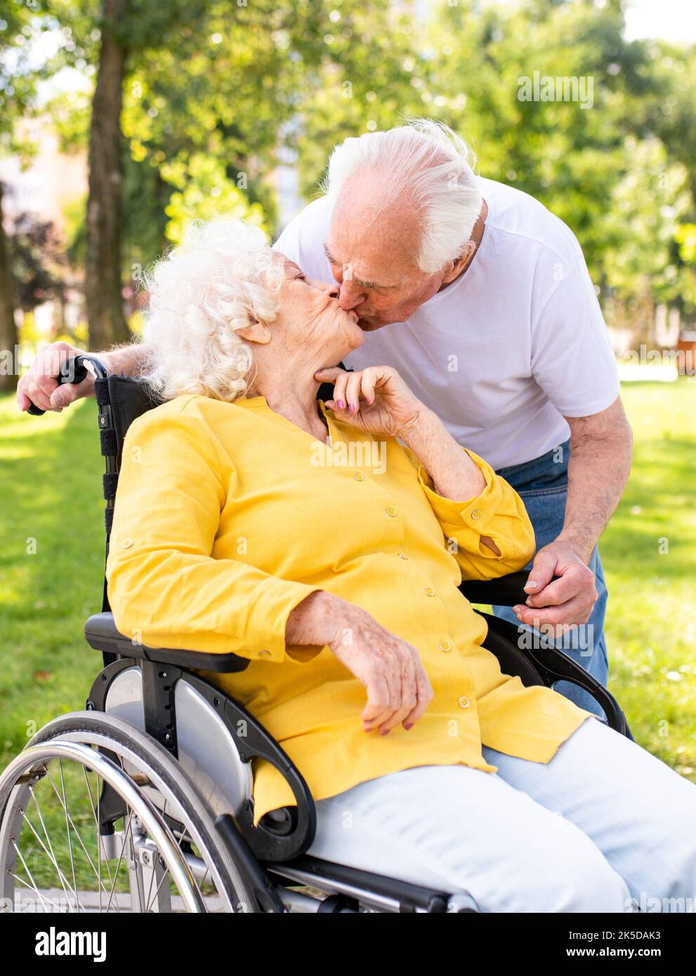 Beautiful senior couple with disability outdoors - Old people in the ...