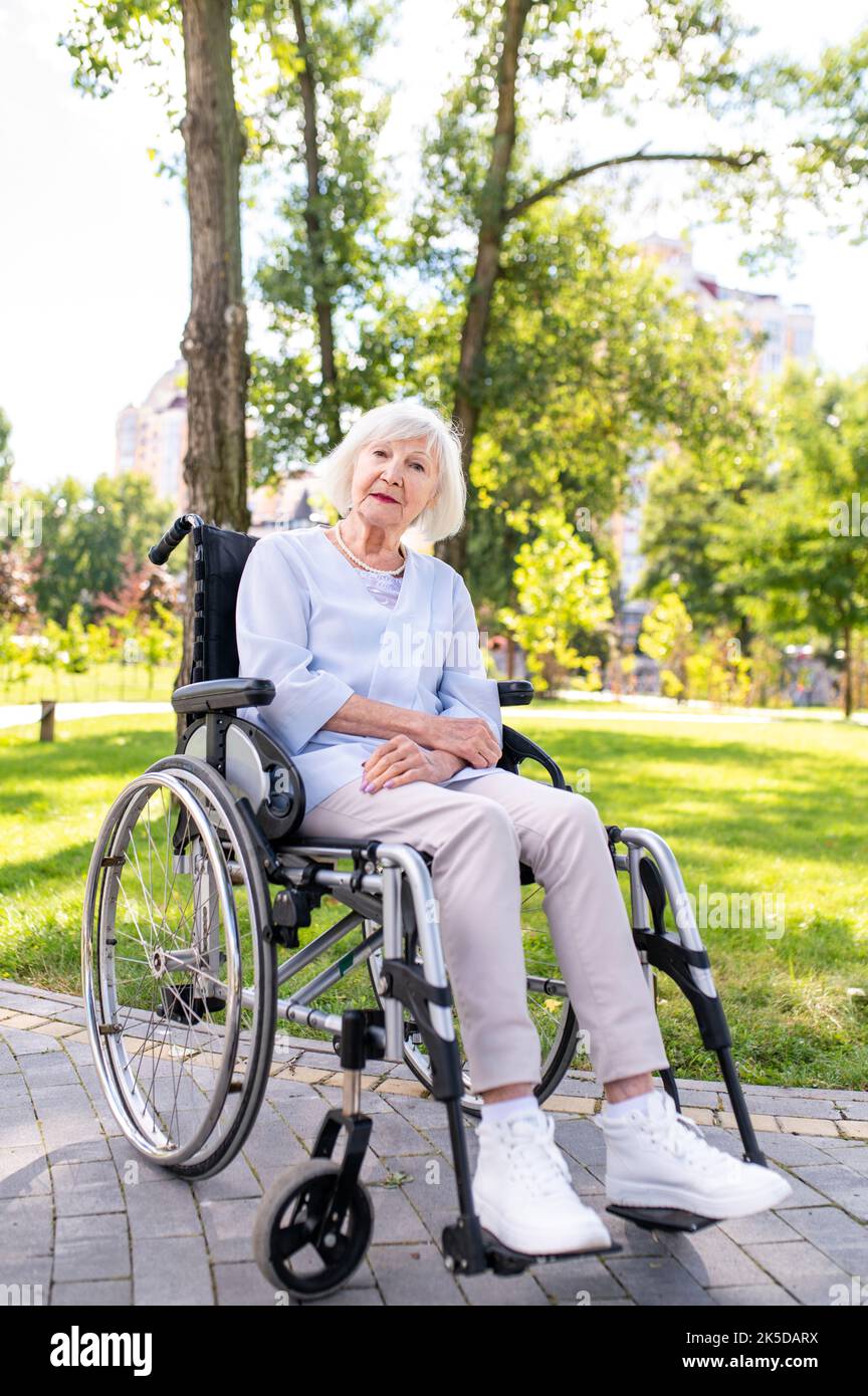 Beautiful senior woman with disability outdoors - Old people in the age ...