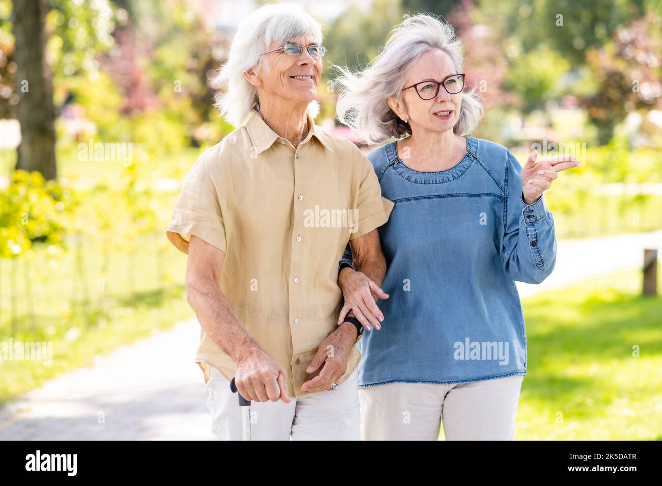 Beautiful senior couple with disability outdoors - Old people in the ...
