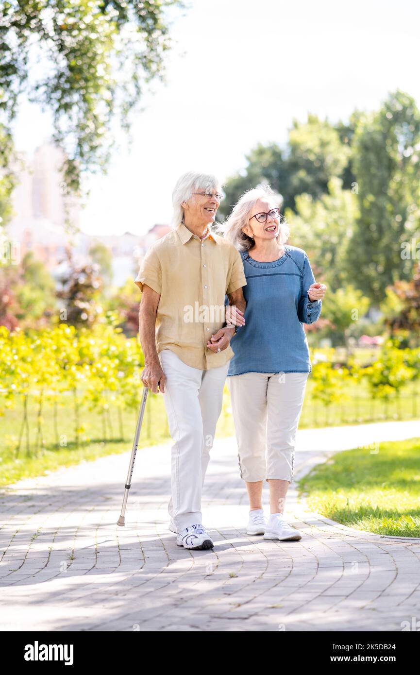 Beautiful senior couple with disability outdoors - Old people in the ...