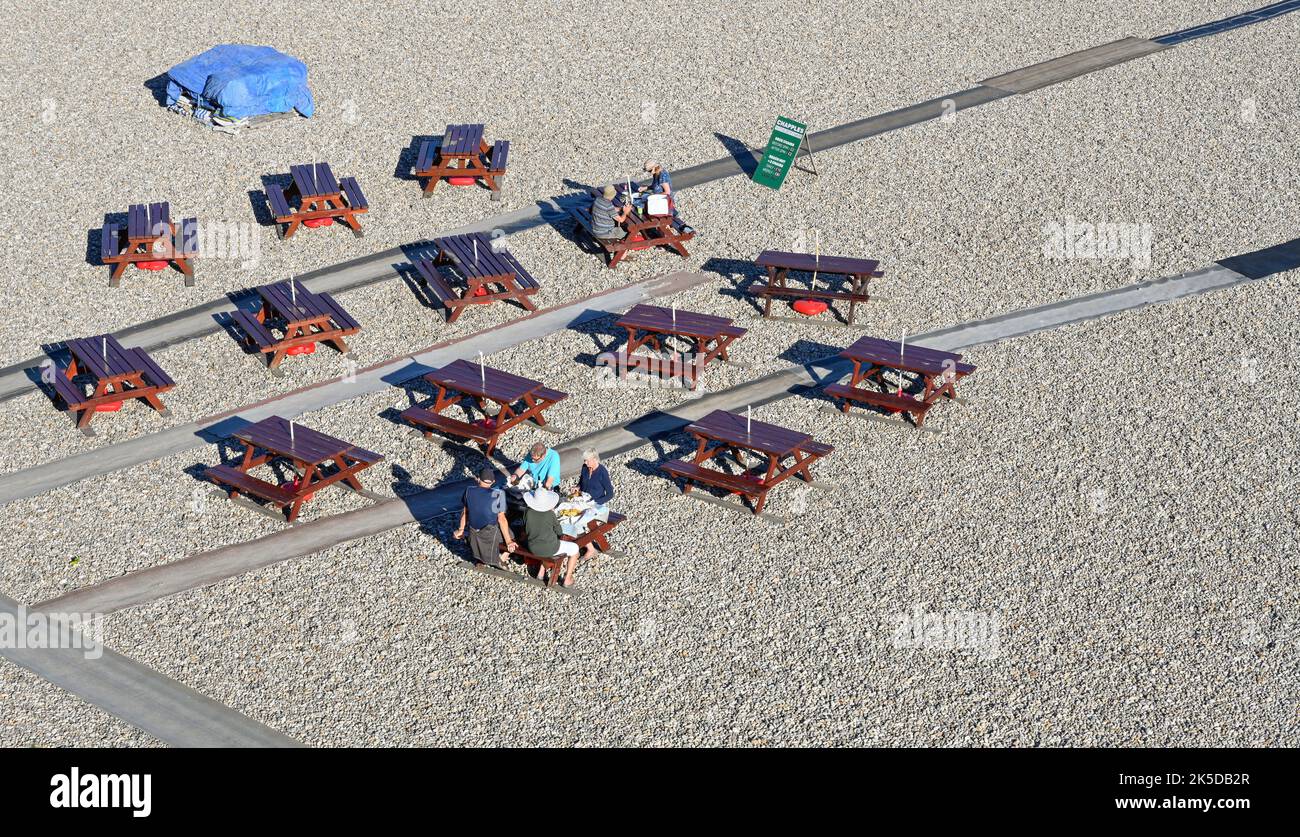 Beer Devon Beach with tourists enjoying the last cuppa Stock Photo - Alamy