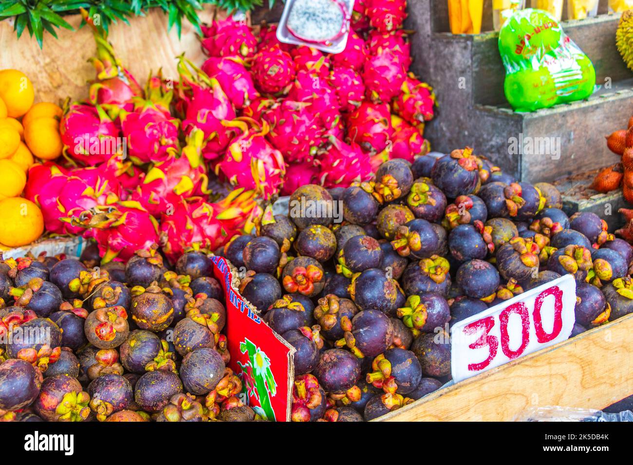 Purple pink pitaya dragon fruit and mangosteen in thai market at ...