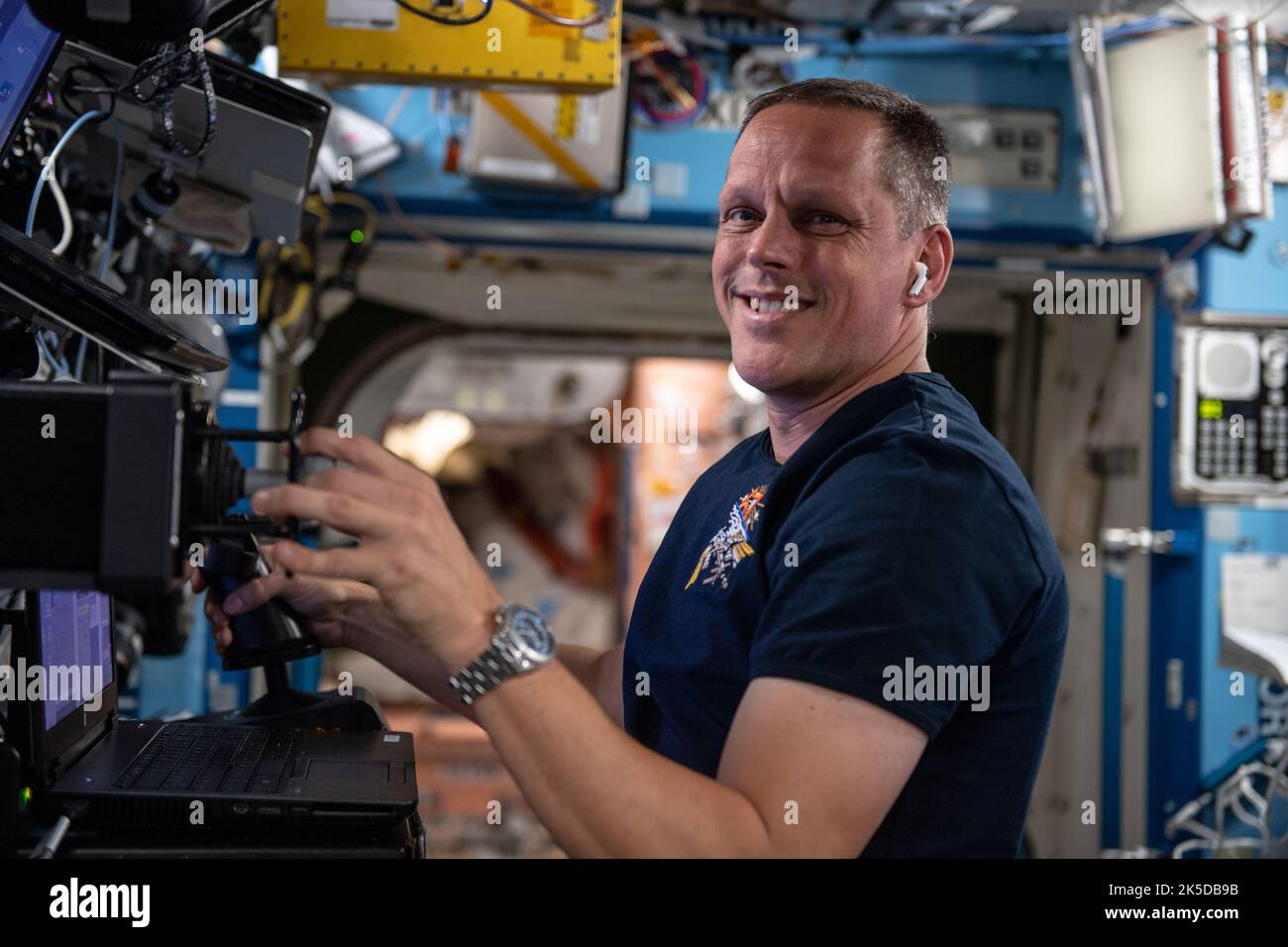 NASA astronaut Bob Hines performs a robotics test on the Destiny ...