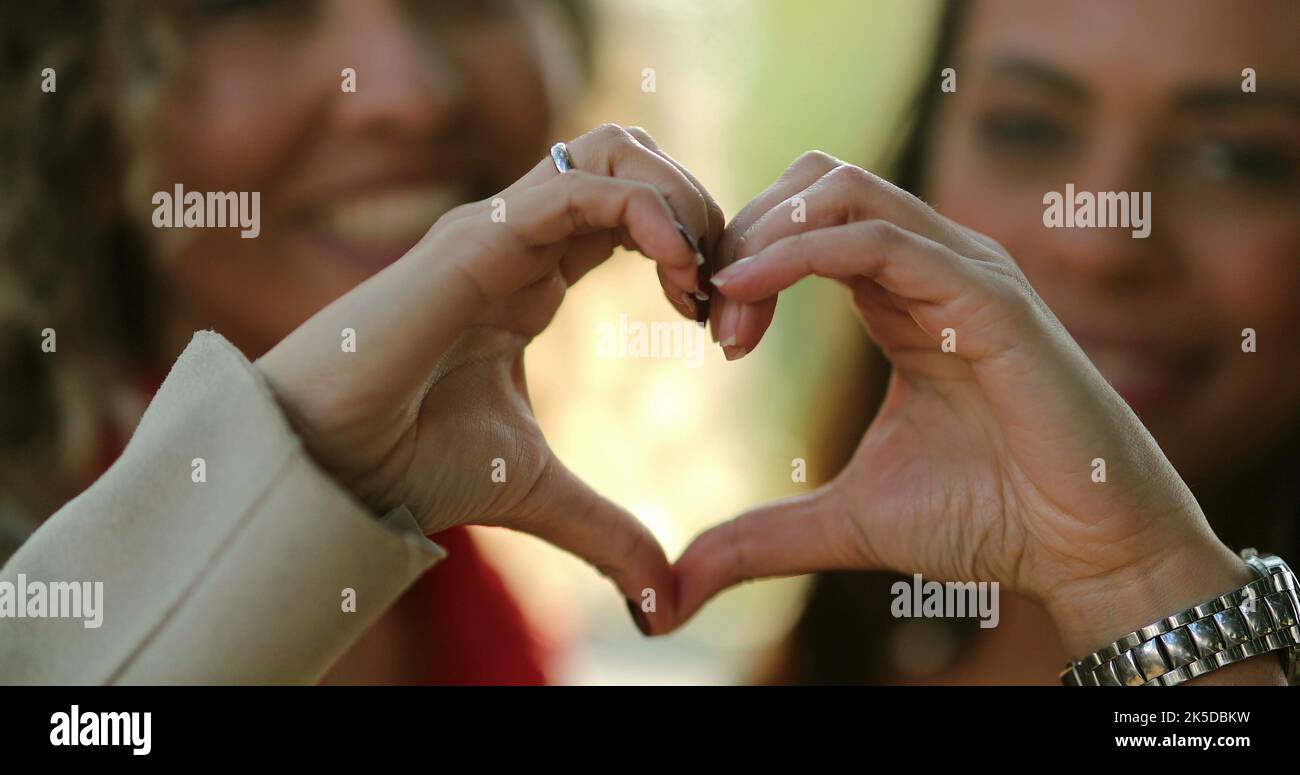 People showing solidarity with heart symbol hands Stock Photo - Alamy