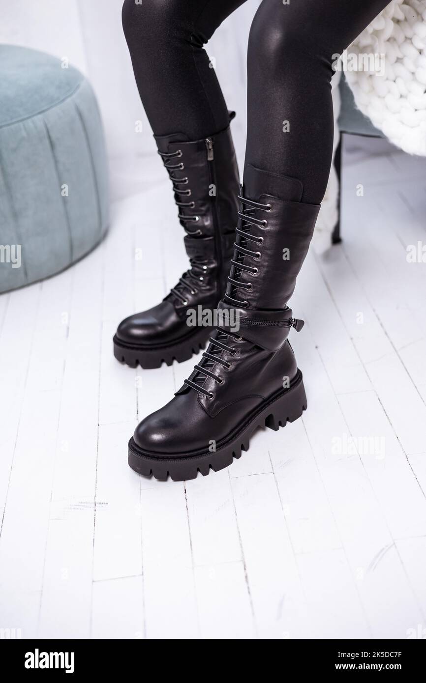 Woman in black leather boots from the new collection. Woman's legs in ... Woman in black leather boots from the new collection. Woman's legs in ...