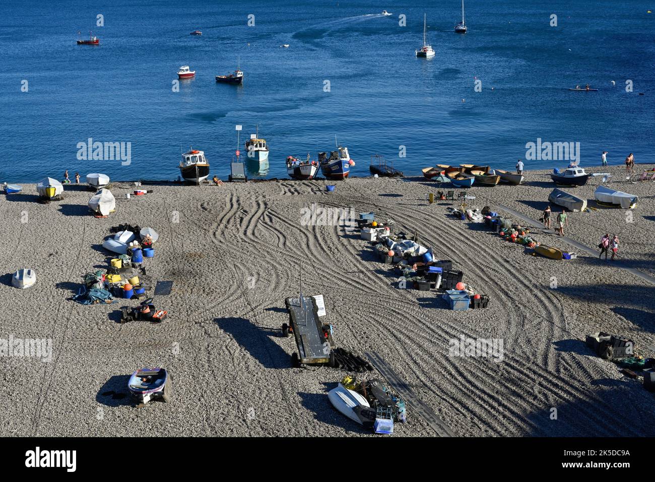 Fishing boats on Beer Beach from the South Coast Path and cliff top ...
