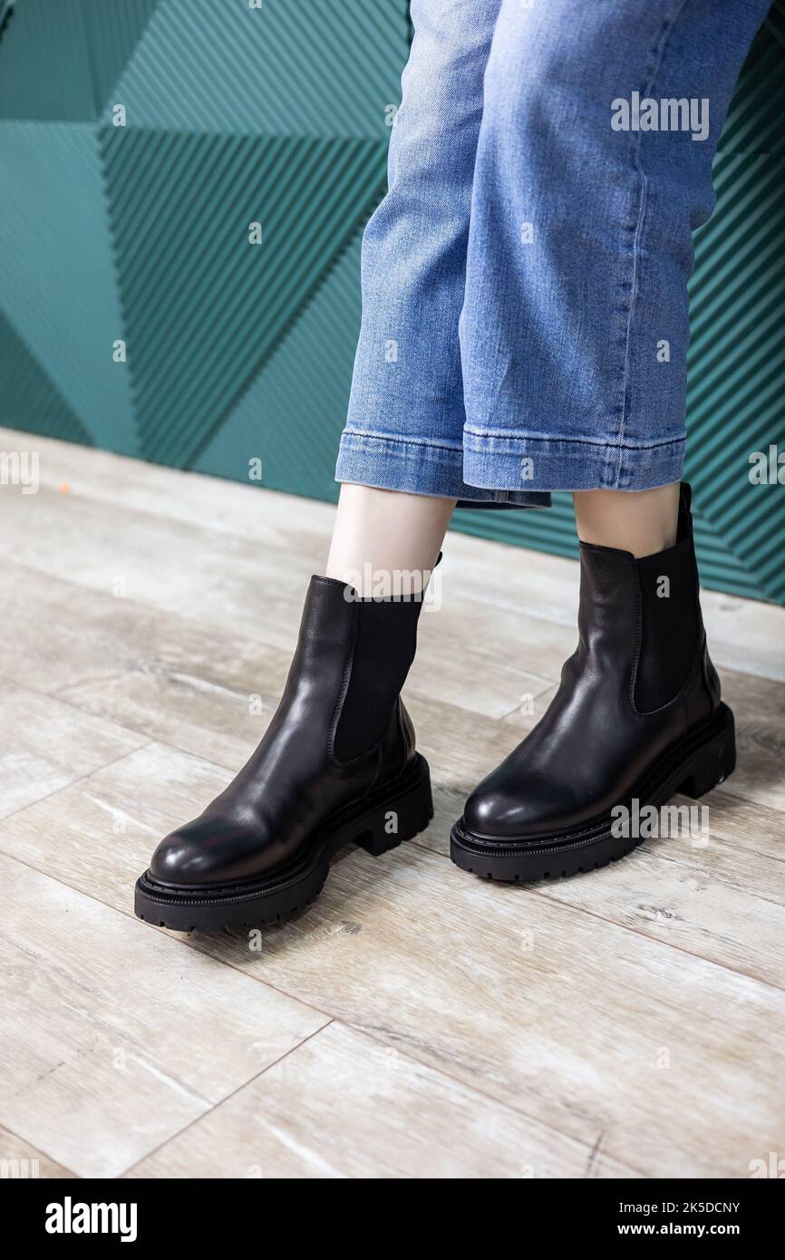 Beautiful female legs in leather boots and jeans. Female legs in ...