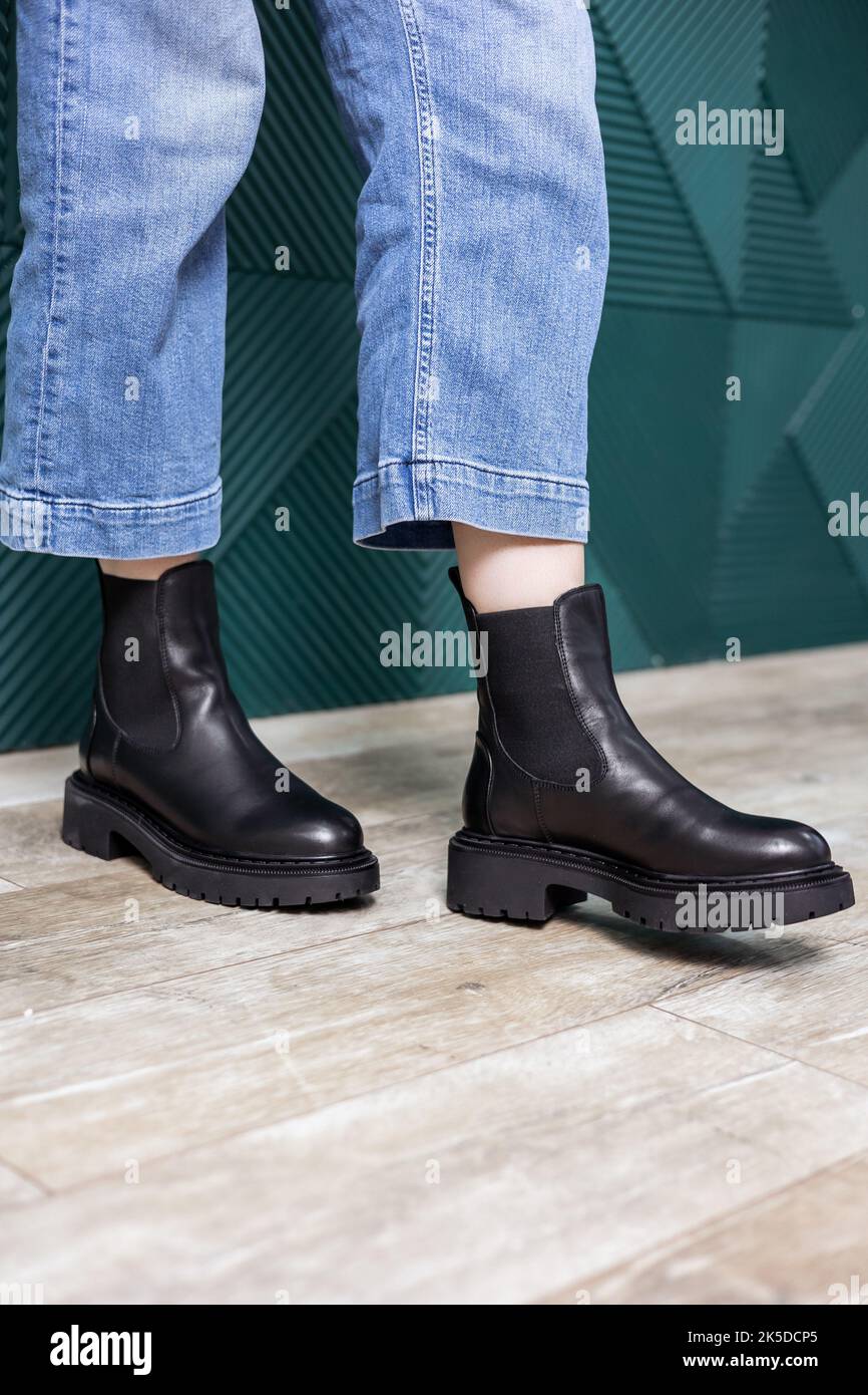Beautiful female legs in leather boots and jeans. Female legs in ...